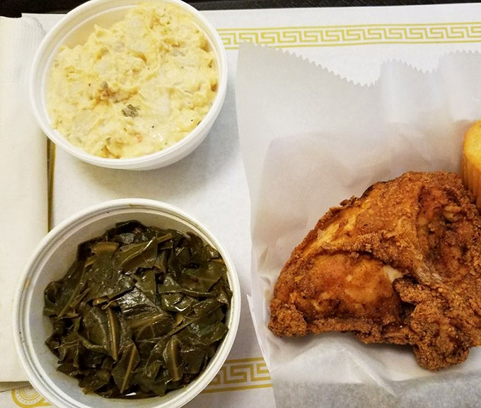 Soul food trinity: tender collard greens, creamy potato salad, and that chicken&mdash;crispy on the outside, juicy within&mdash;a holy experience for your taste buds.