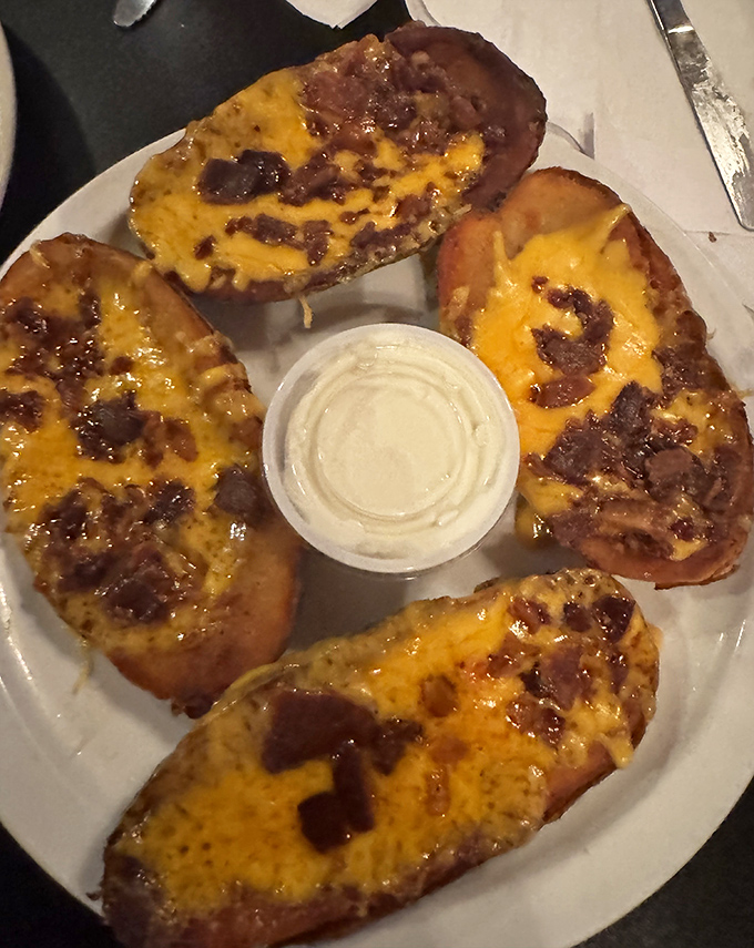 Potato skins loaded with melted cheese and bacon &ndash; the kind of appetizer that makes you wonder why we ever bothered inventing fancy food.
