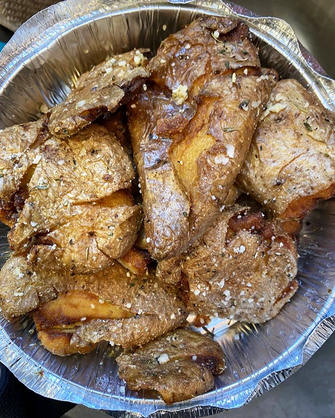 These spuds aren't just potatoes; they're little crispy vehicles for herbs, parmesan, and happiness, glistening with possibility.