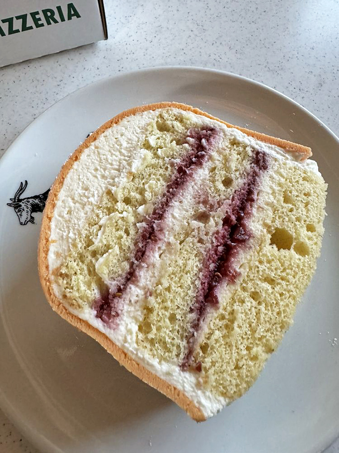 A cross-section of the legendary princess cake reveals its secrets: delicate sponge, raspberry preserves, and cream layers that would make Swedish royalty weep.