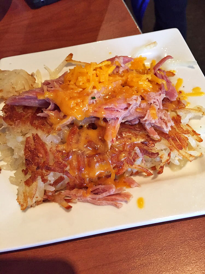 Hash brown real estate topped with pulled pork and melted cheese. If this doesn't make you set your alarm for breakfast, check your pulse immediately.