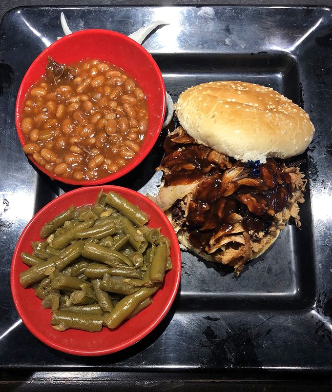 This pulled pork sandwich requires both hands and absolutely zero dignity to properly enjoy.