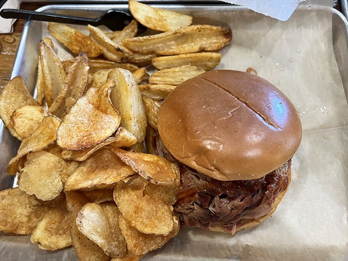 This pulled pork sandwich isn't messing around. The meat-to-bun ratio is spot-on, and those house-made chips are the supporting actors who deserve their own award.