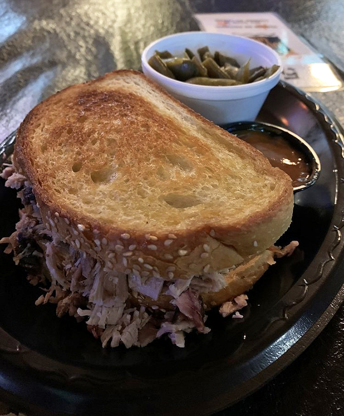 Pulled pork piled so generously it's practically escaping the bun, with mac and cheese that's unapologetically yellow and proud.