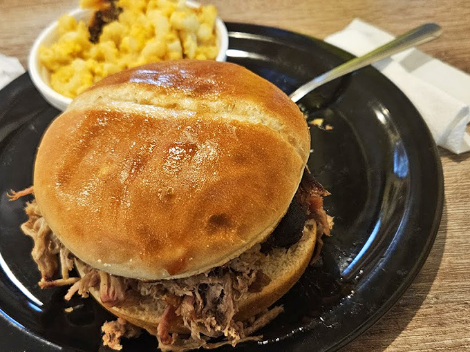 This pulled pork sandwich isn't just a meal&mdash;it's an engineering marvel of tender meat and soft bun. The mac and cheese sidekick steals scenes.