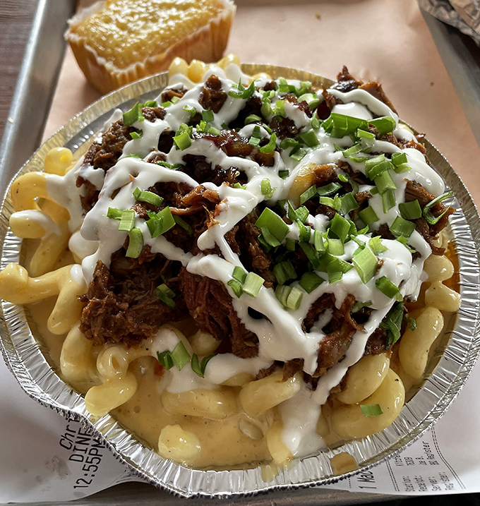 Mac and cheese topped with pulled pork and drizzled with sauce&mdash;because sometimes the best things in life are the ones that require an extra napkin or three.