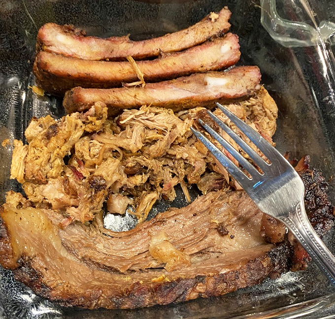 Fork-tender pulled pork alongside ribs that would make Fred Flintstone jealous. This is Tennessee's edible architecture at its finest.