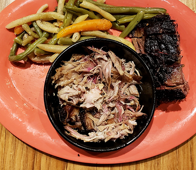 Pulled pork that's had a proper introduction to smoke and time. Served with green beans that somehow avoid the dreaded cafeteria comparison.