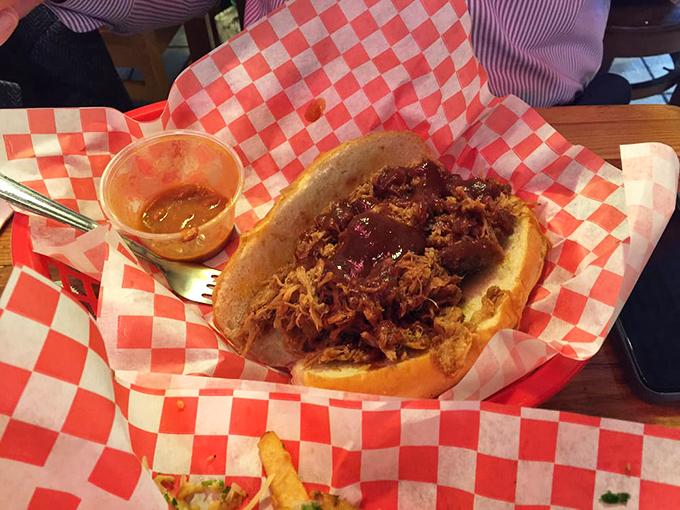 The sandwich that launched a thousand road trips. This pulled pork masterpiece delivers that perfect balance of smoke, meat, and sauce that haunts your dreams.