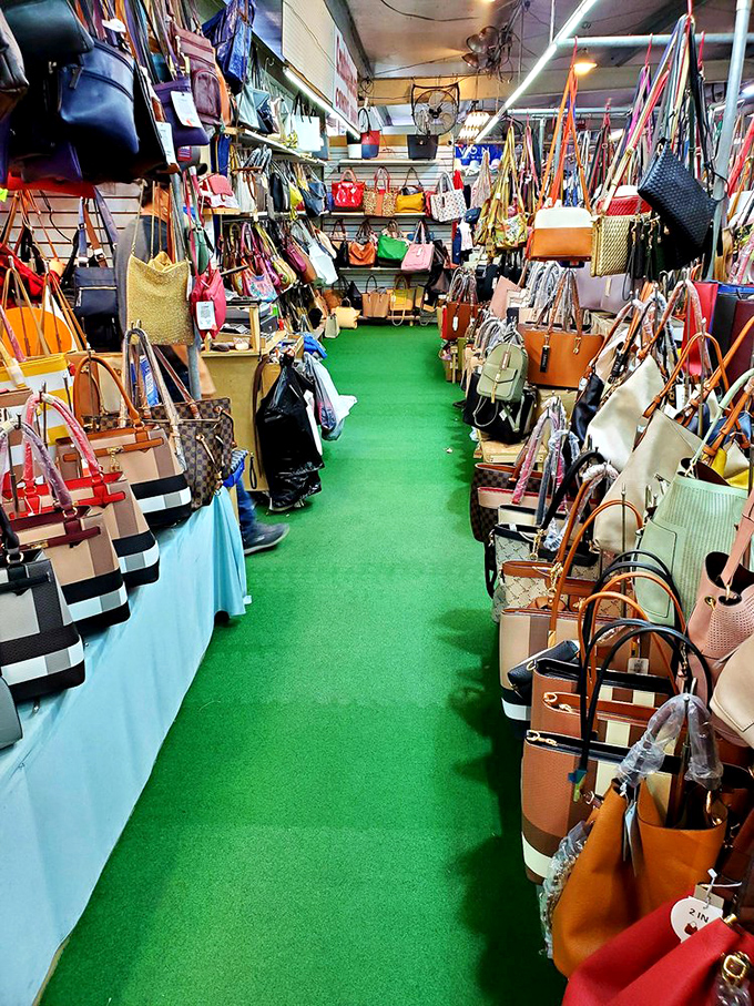 Handbag alley, where designer dreams meet budget realities on a sea of green carpet that's seen thousands of fashion decisions.
