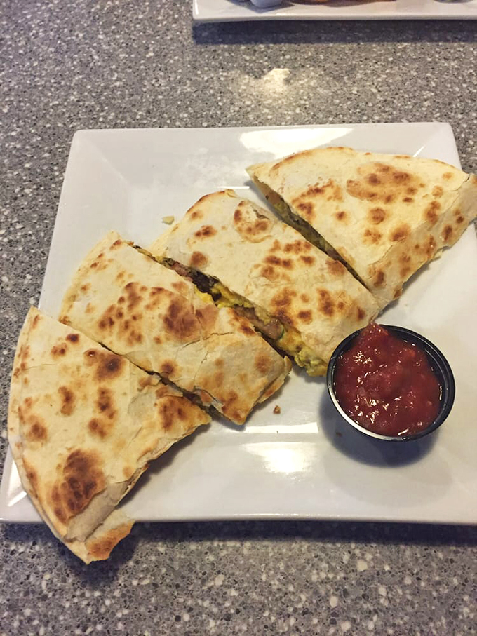 Golden-brown quesadilla triangles with that perfect cheese pull, served with a side of salsa that's saying, "Go ahead, dip me. You know you want to."