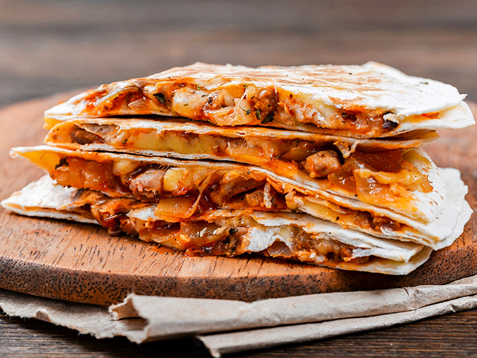 Quesadillas that don't just cross borders&mdash;they demolish them. Stuffed with enough filling to make you wonder if they're charging by the pound.