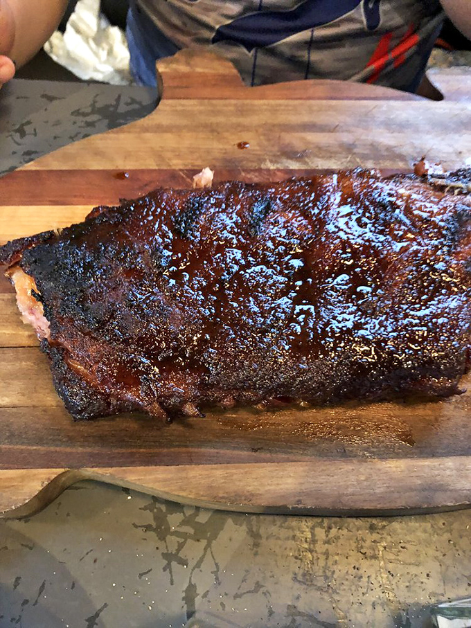 This rack of ribs has the kind of bark that makes tree bark jealous. The glistening exterior promises a flavor explosion that delivers with every bite.