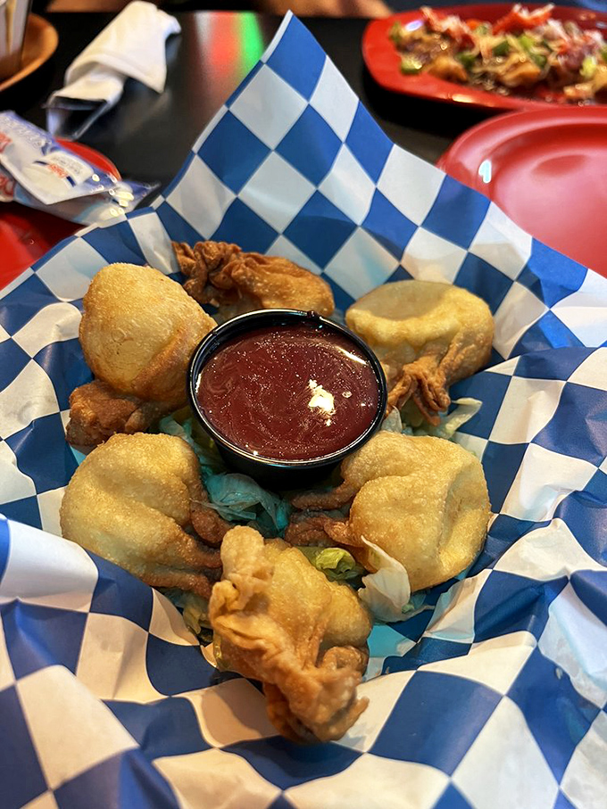 Golden-fried perfection with a side of sweet-spicy sauce—these aren't just appetizers, they're little edible treasures worth fighting over.