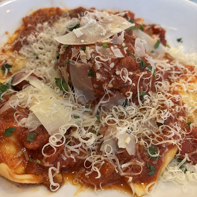 Ravioli crowned with shaved parmesan and bathed in rich sauce&mdash;proof that the simplest pleasures are often the most profound.