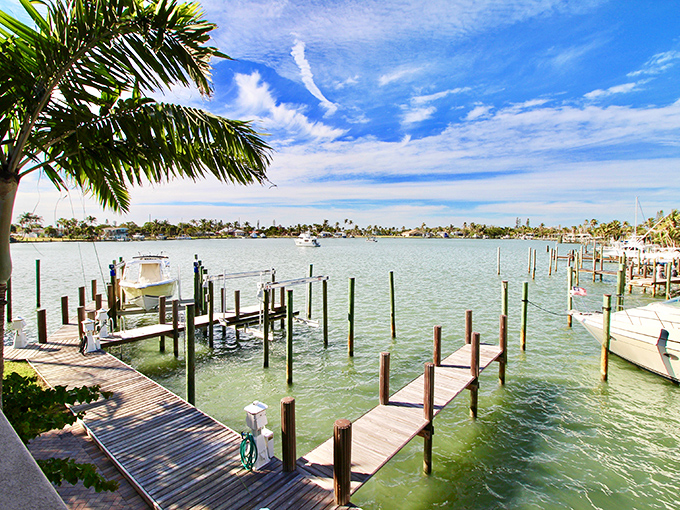 The marina's wooden docks create a geometric ballet of lines and reflections &ndash; each slip a parking space for someone's floating piece of freedom.