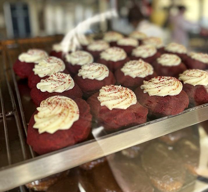 Red velvet donuts topped with cream cheese frosting &ndash; proof that sometimes the best things in life come in crimson packages.