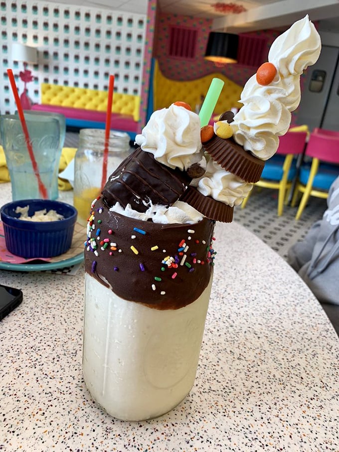 Dessert architecture at its finest! Chocolate-dipped rim, towering whipped cream, candy garnishes&mdash;this milkshake isn't just a drink, it's performance art you can consume. 