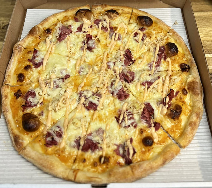 The Reuben pizza—where deli sandwich meets pizza pie in a cross-cultural romance that works surprisingly well.