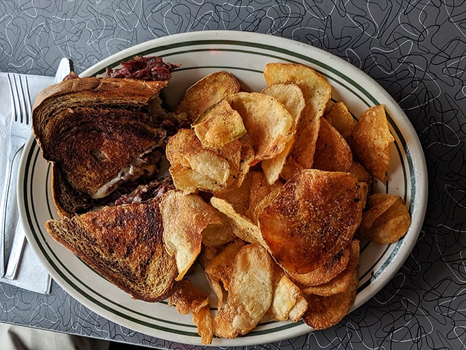 A Reuben sandwich that doesn't mess around, flanked by homemade chips that shatter with each satisfying crunch.