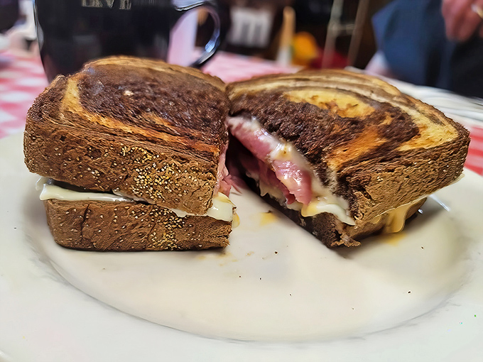 The Reuben arrives like a sandwich celebrity&mdash;grilled to golden perfection with a tantalizing cross-section revealing layers of corned beef, sauerkraut, and melted Swiss.