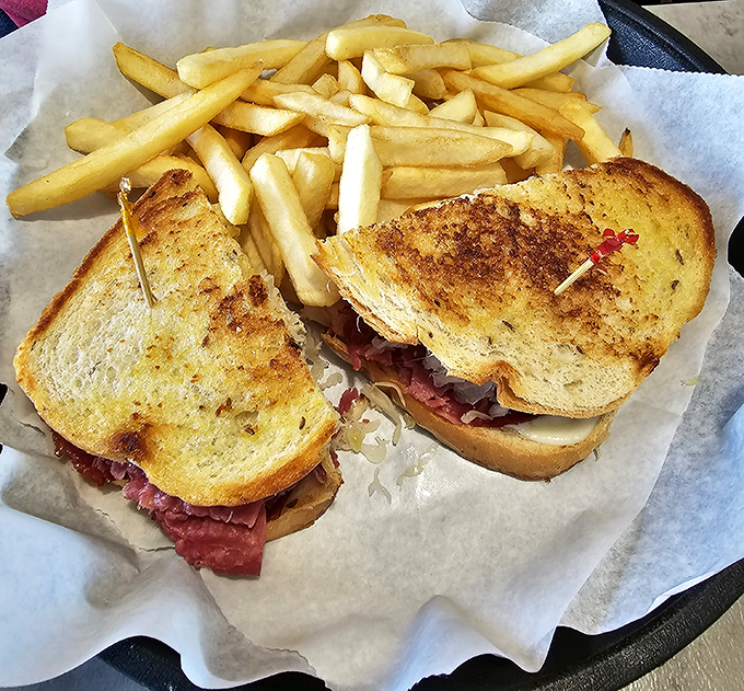A proper Reuben doesn't hide behind pretense. This beauty flaunts its perfectly grilled bread and generous filling alongside hand-cut fries.