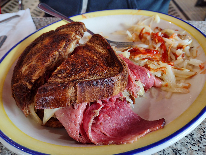 The Reuben sandwich &ndash; where thinly sliced corned beef meets sauerkraut in a dance so perfect it deserves its own Broadway show, with hashbrowns playing supporting role.