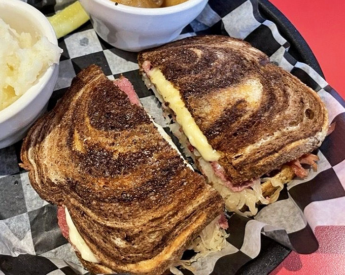That's not just a Reuben sandwich; it's a masterpiece of marbled rye, melted cheese, and meat that would make Manhattan delis stand up and salute.