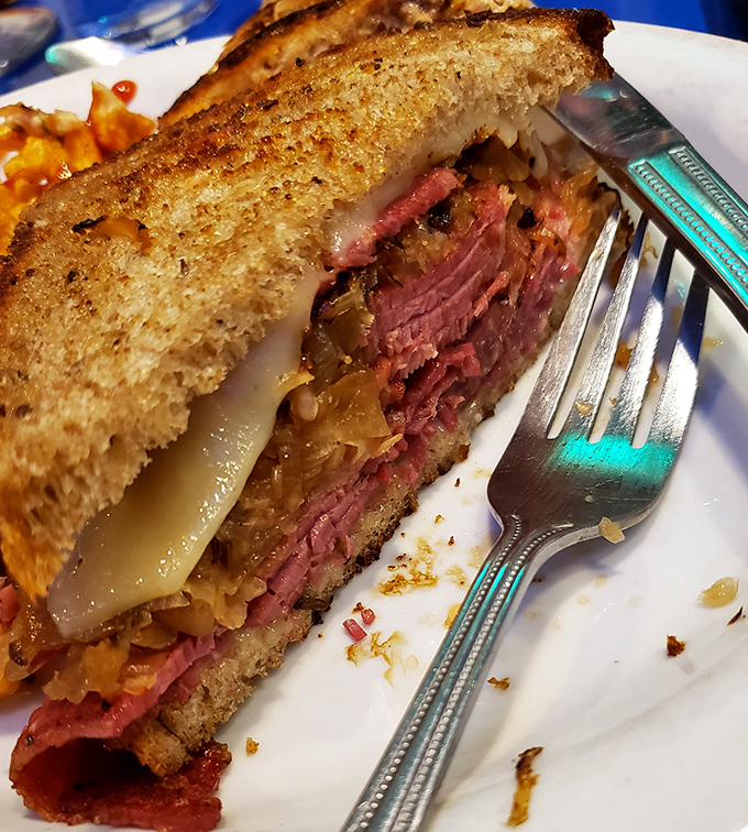 The Reuben sandwich: where corned beef, sauerkraut, and Swiss cheese perform a perfectly choreographed dance between two slices of grilled rye bread.