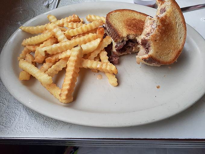 That half-eaten Reuben tells the whole story&mdash;crispy grilled rye, melted cheese, and the kind of satisfaction that requires no filter or hashtag.