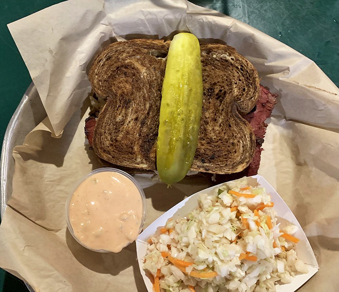 This Reuben isn't just a sandwich; it's architecture with purpose, where each layer contributes to the structural integrity of deliciousness.