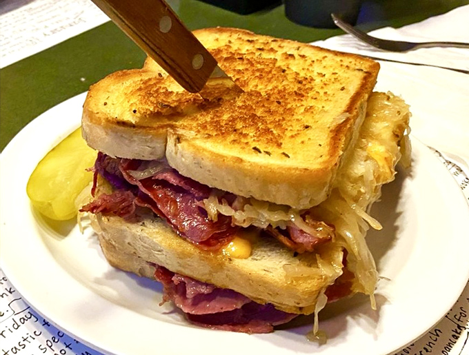 This Reuben isn't just a sandwich—it's a skyscraper of corned beef and sauerkraut that demands respect and extra napkins.