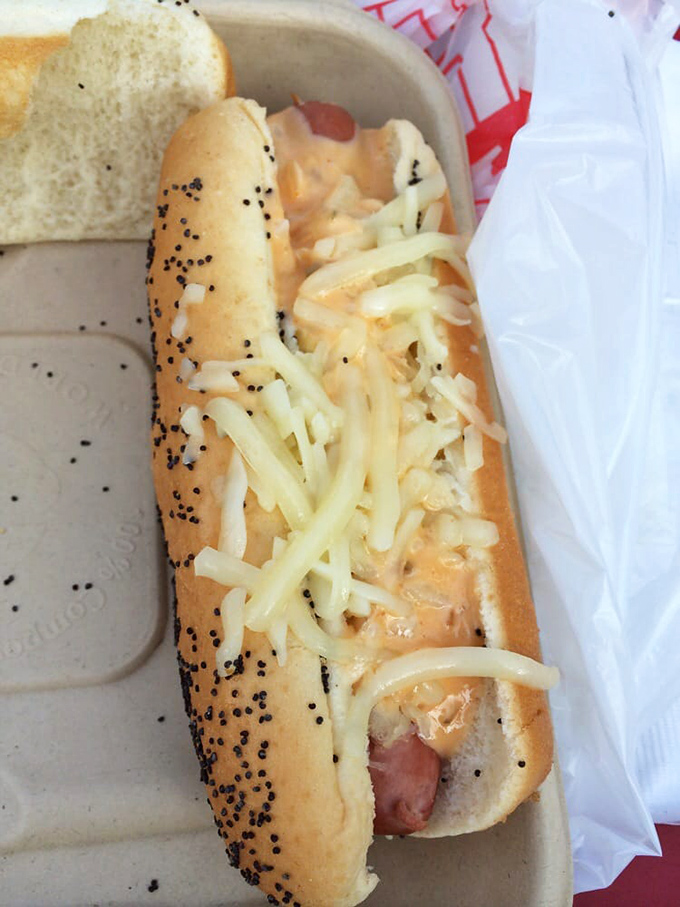 A poppy seed bun cradles this cheese-laden masterpiece, proving that sometimes the best things in life come between two pieces of bread.