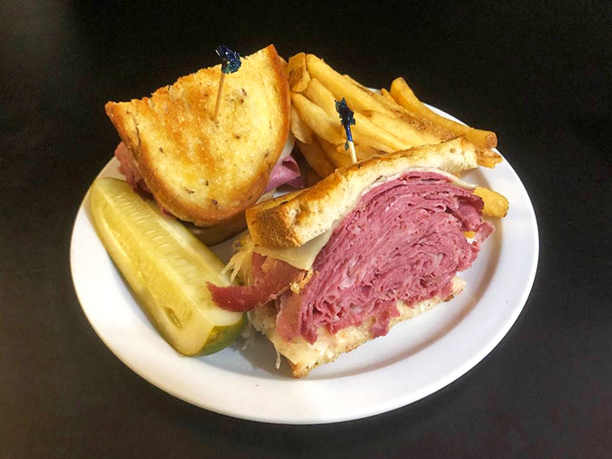 This Reuben isn't just a sandwich; it's an architectural achievement of meat, cheese, and toasted bread that would make any deli aficionado weep with joy.