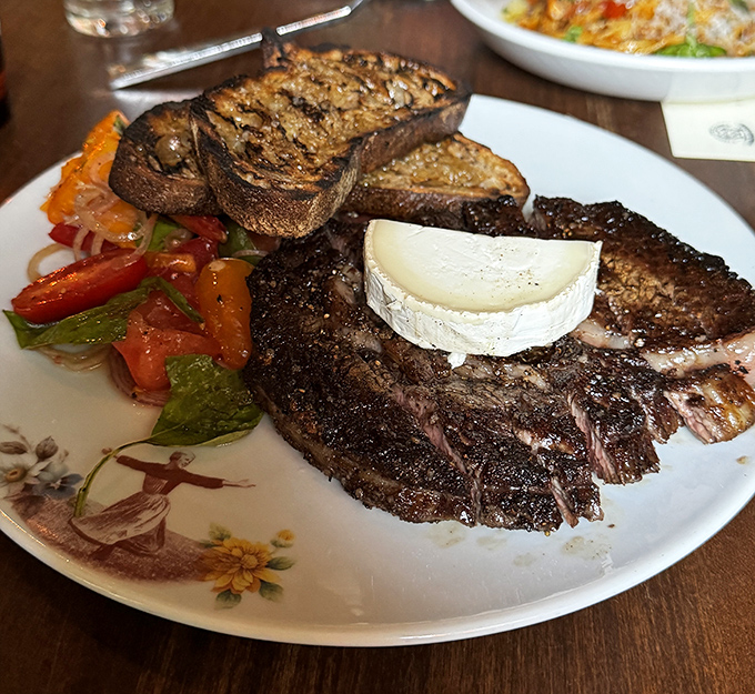 This isn't just steak; it's a carnivore's dream with a cheese sidekick. The char on that ribeye is what backyard grillers spend lifetimes trying to achieve.