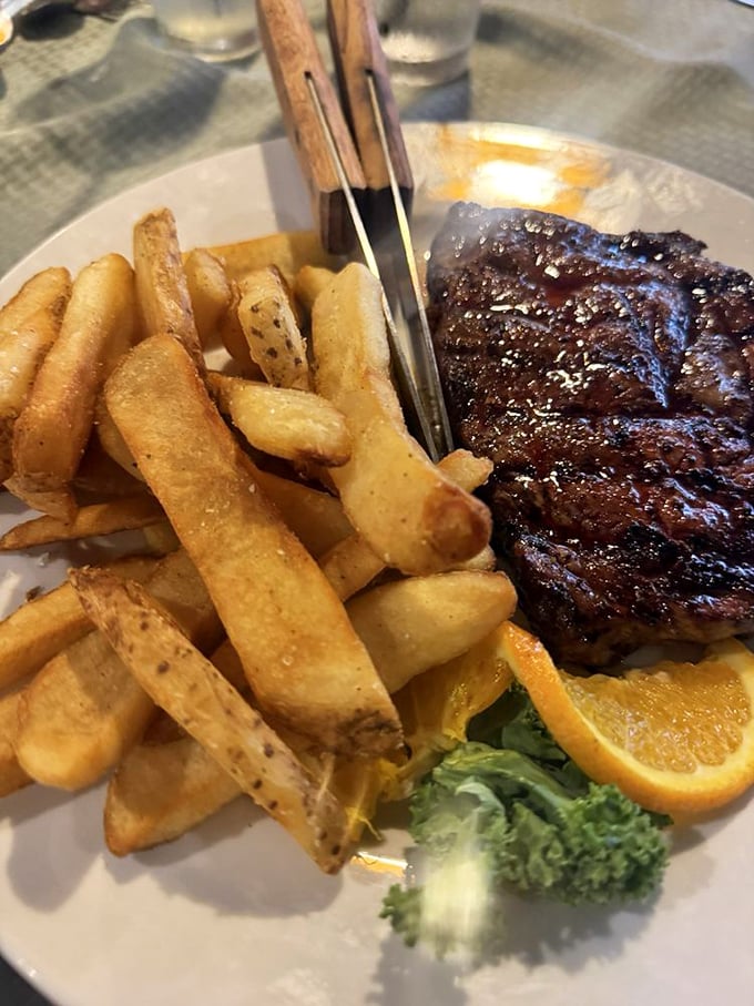 A perfectly seared ribeye with fries that could make a Frenchman weep&mdash;simple perfection that needs no translation.
