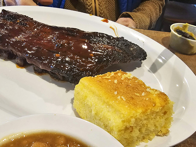 These ribs have that perfect bark-to-meat ratio that barbecue dreams are made of. The cornbread isn't just a side—it's essential equipment.