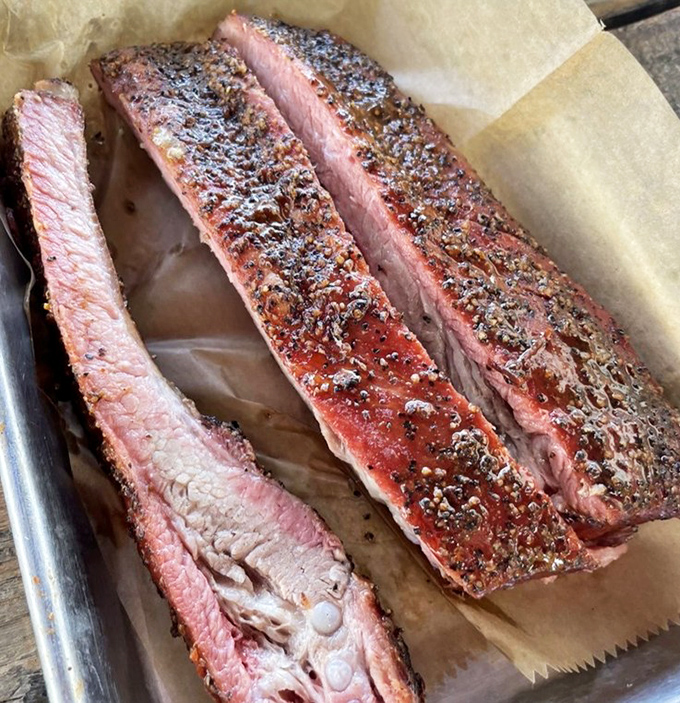 Ribs with that perfect pink smoke ring&mdash;the kind that make you temporarily consider giving up silverware forever and embracing your inner caveman.