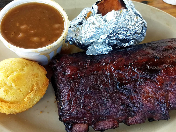 Ribs with that mahogany bark, cornbread that crumbles just right, and beans that have clearly been fraternizing with the meat. Perfection on a plate.