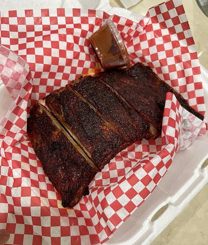 These ribs have the kind of bark that makes tree bark jealous—a perfect canvas for that little cup of sauce waiting patiently for its moment.