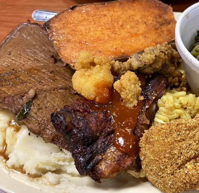 The holy trinity of Southern plate architecture: slow-roasted beef, cornbread that crumbles just right, and sides that refuse to be called "supporting cast."