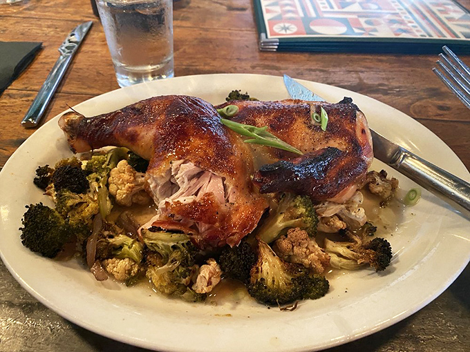 Roasted chicken resting on a bed of broccoli and cauliflower proves that comfort food doesn't have to be complicated to be magnificent.