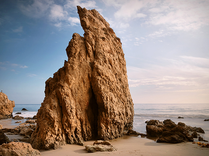 Not your average beach rock. This towering formation could easily be mistaken for something from a fantasy film set rather than natural California coastline.