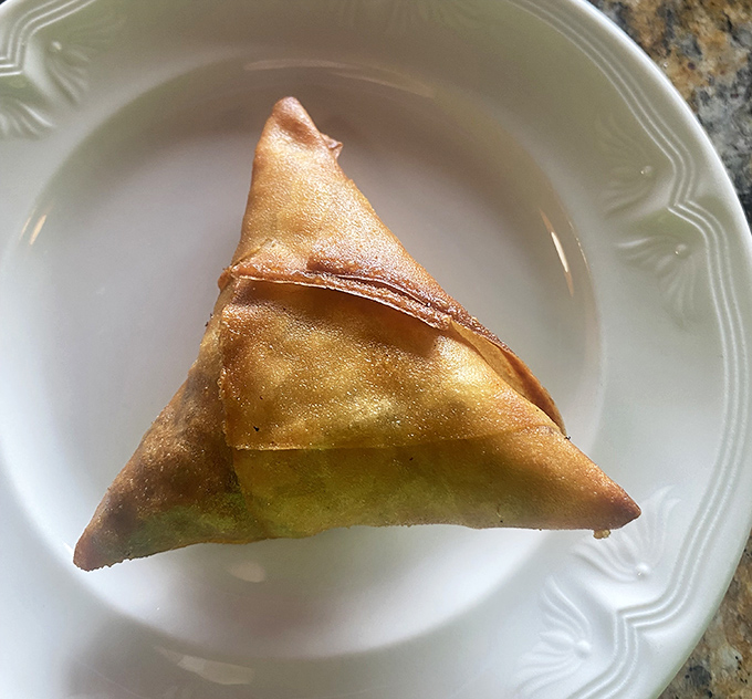 The sambusa triangle&mdash;crispy, flaky, and filled with savory goodness. Like an empanada that went to graduate school and came back worldly and sophisticated.