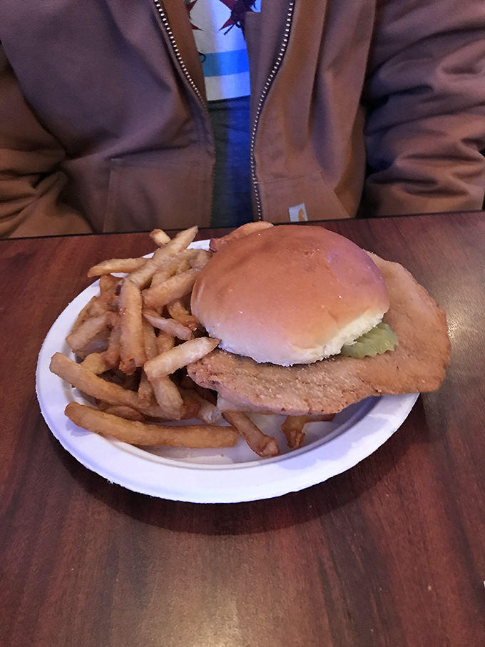 The pork tenderloin sandwich extends so far beyond the bun it needs its own zip code. Midwestern excess at its most delicious.