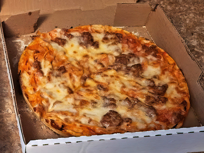 Melted cheese cascading over sausage and sauce&mdash;this isn't just dinner, it's a warm hug in circular form.