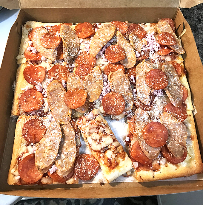 The sausage and pepperoni combo creates a meat-lover's masterpiece on that signature square crust &ndash; a flavor symphony conducted by decades of experience.