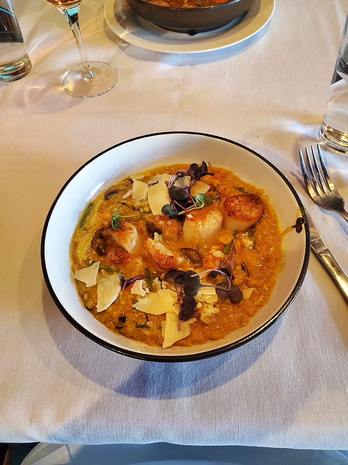 This scallop risotto isn't just a dish, it's a masterclass in texture. Those perfectly seared scallops are the valedictorians of the seafood world.