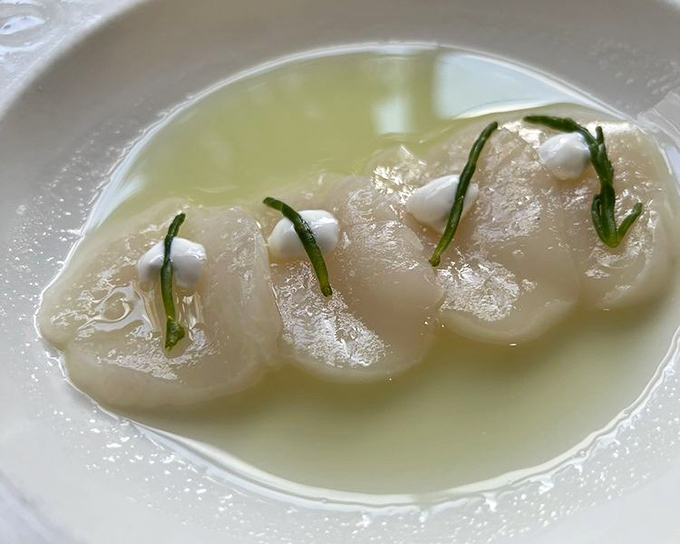 Scallops so delicate they practically whisper to you. Bathed in butter and adorned with fresh herbs—simplicity that speaks volumes.