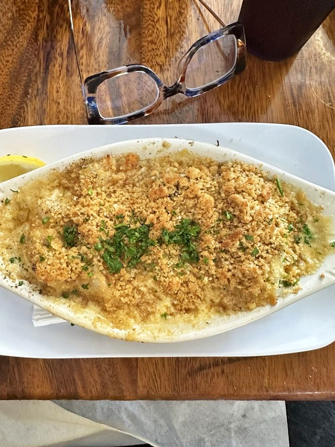 This bubbling seafood casserole arrives looking like comfort food dressed up for Sunday dinner.